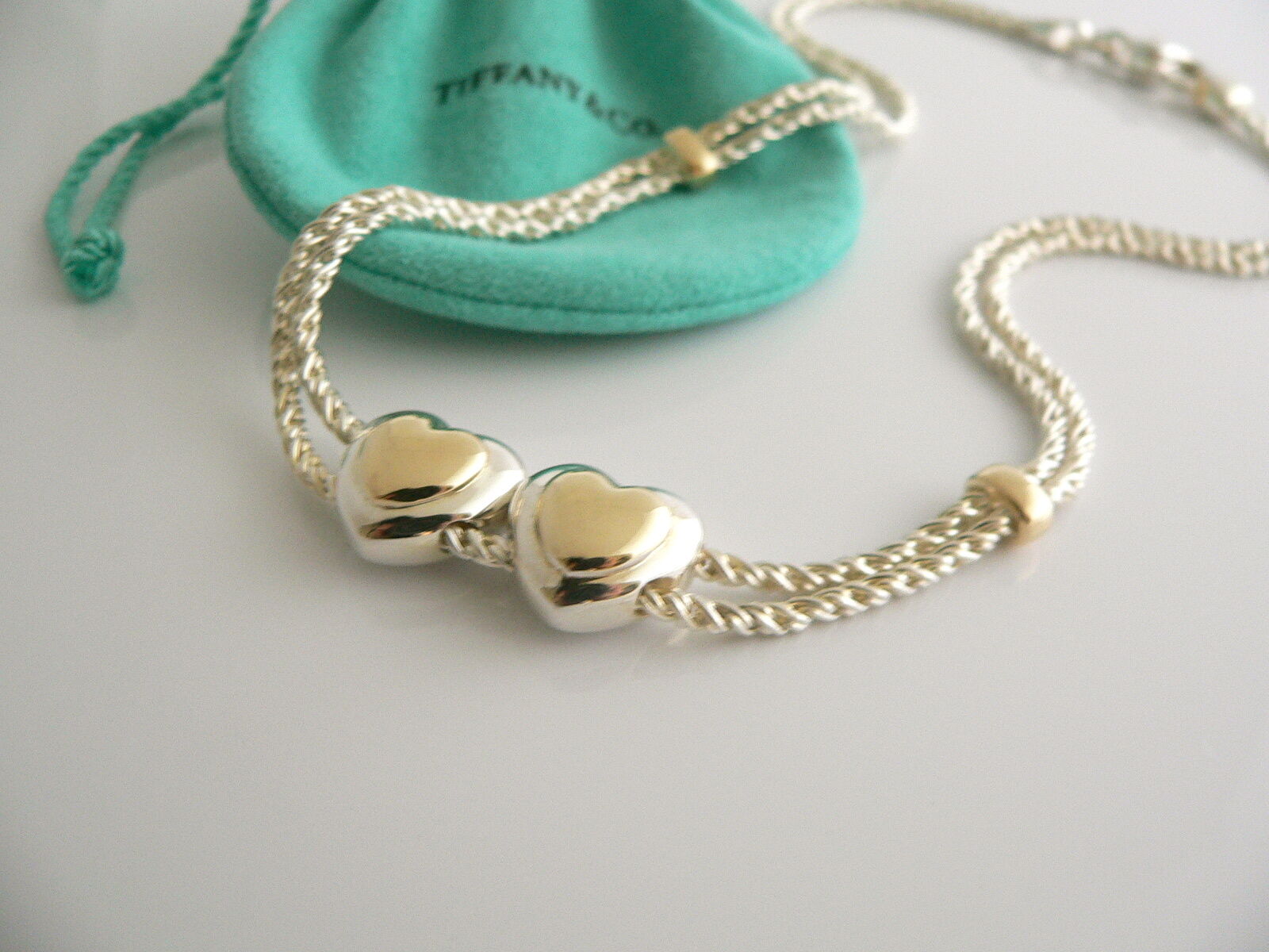 Home › Tiffany & Co Silver 18K Gold Double Rope Sliding Puff Heart ...