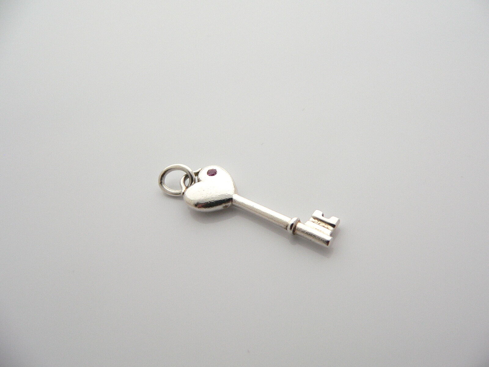 Home › Tiffany Co Silver Pink Sapphire Heart Key Pendant Charm Necklace ...